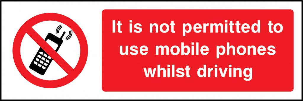 It is not permitted to use mobile phones whilst driving sign ...